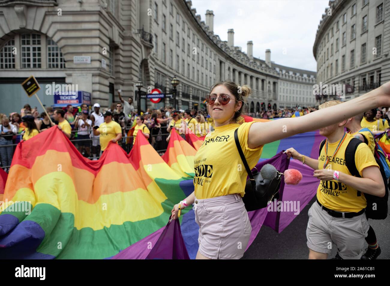 Pride steward holding on a Giant Pride Flag while greeting people ...