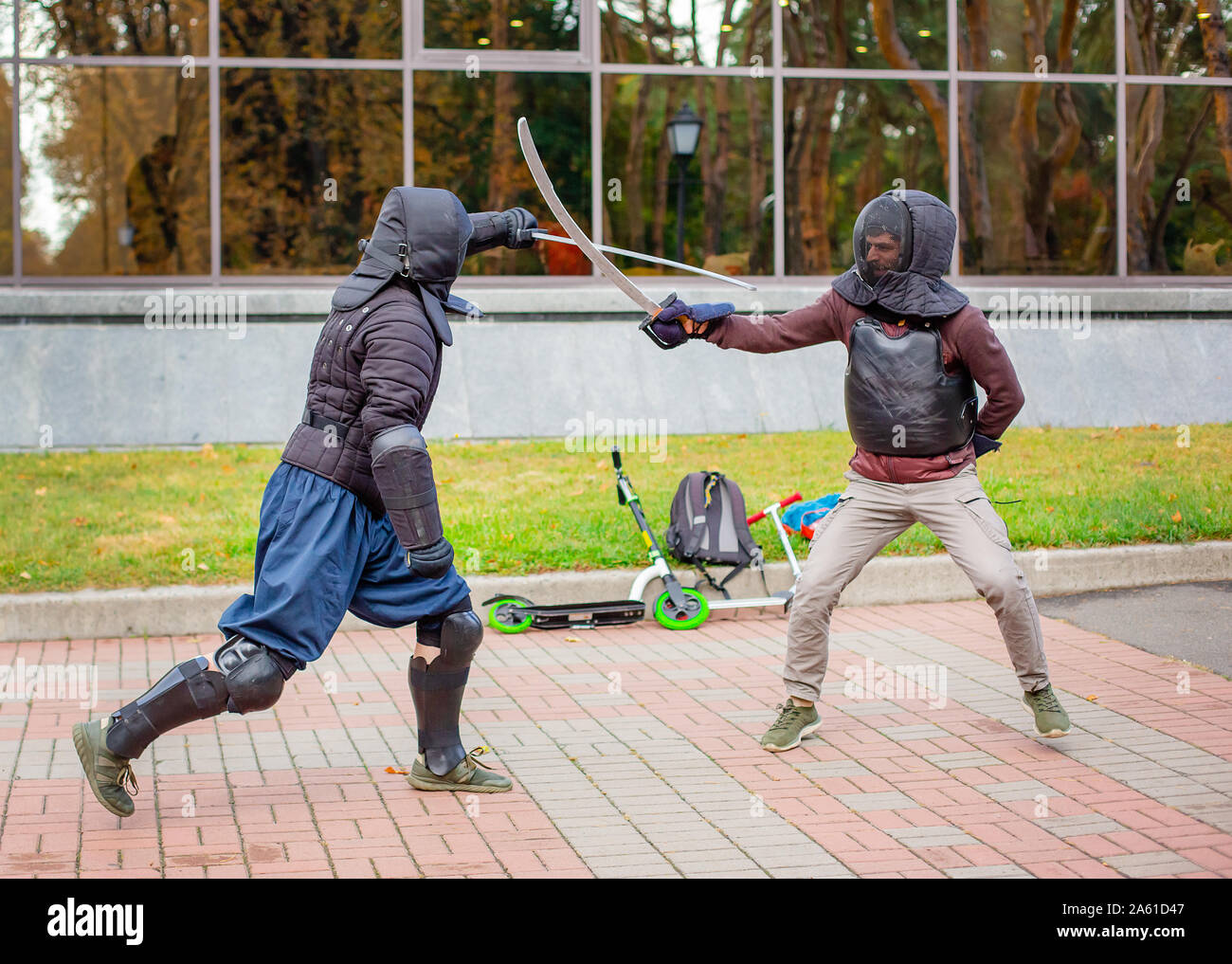 Two armed men lead a sword fight, a medieval fight, at a fun medieval ...