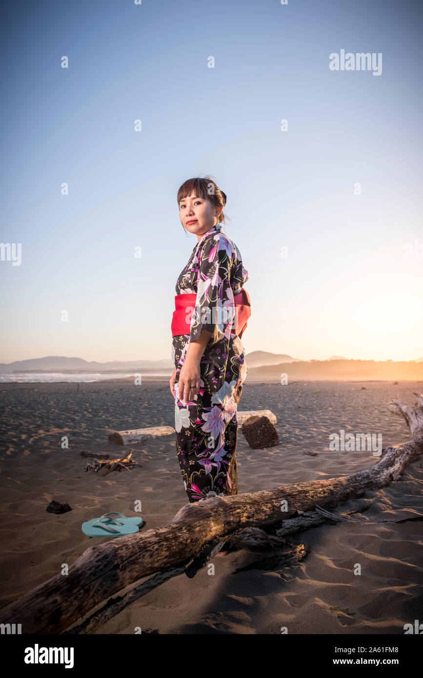 A serene moment at Irino Beach in Shikoku, where a woman in a ...