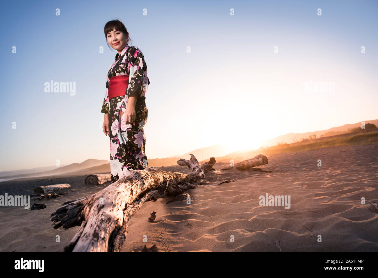 A serene moment at Irino Beach in Shikoku, where a woman in a ...