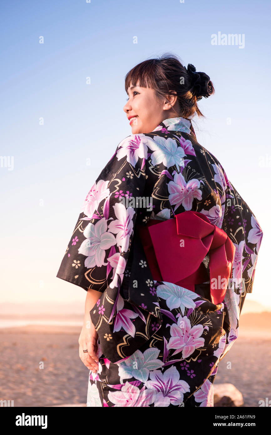 A serene moment at Irino Beach in Shikoku, where a woman in a ...