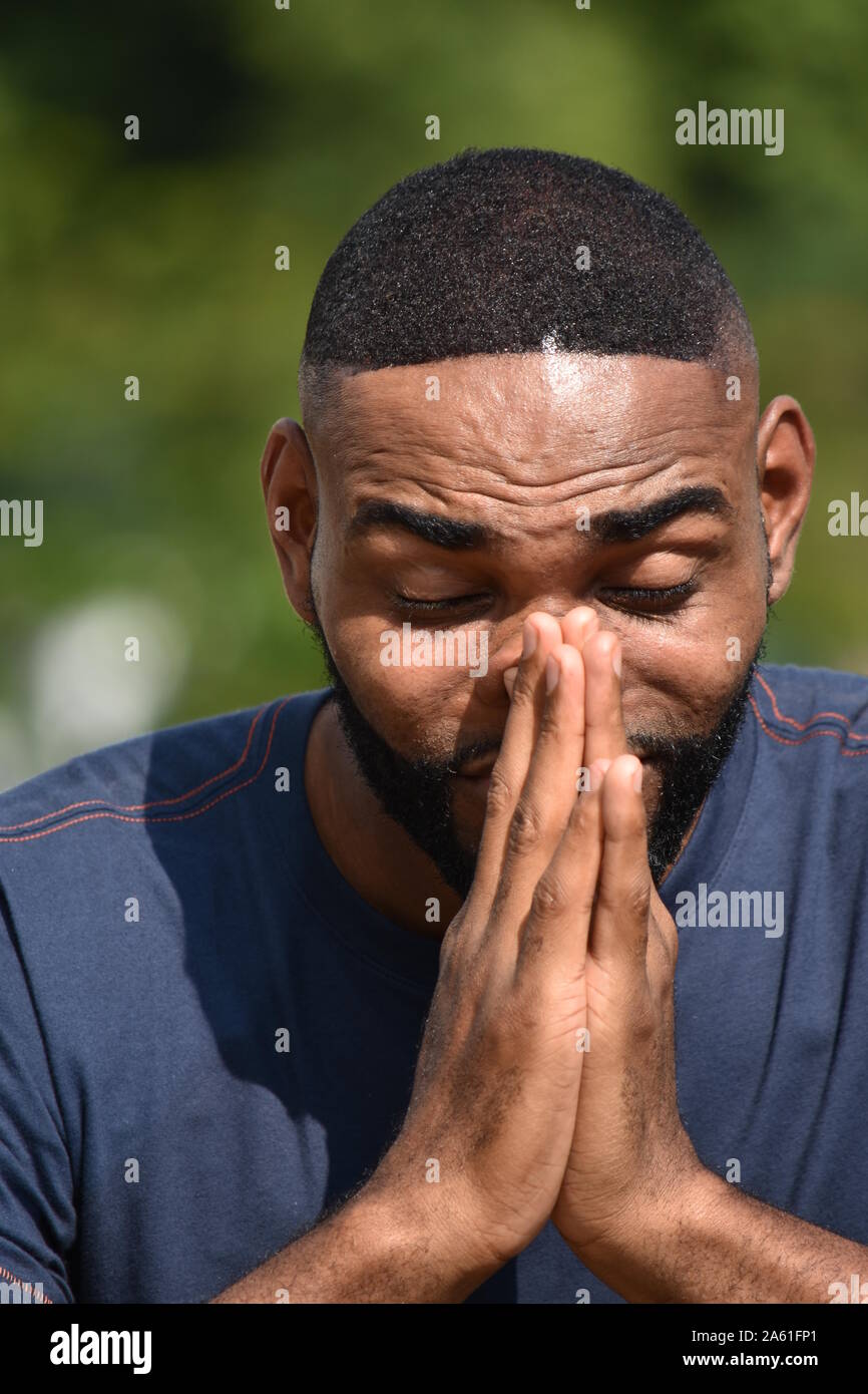 Black Man In Suit Praying