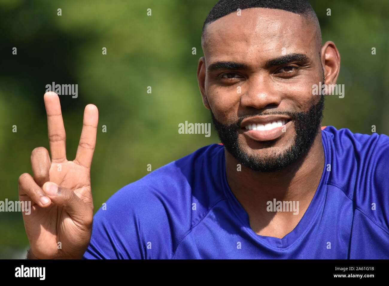 Male Athlete And Peace Sign Stock Photo - Alamy