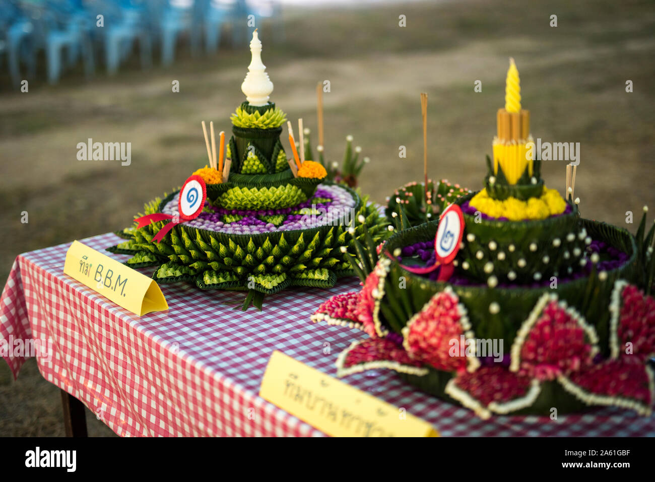 A beautifully crafted Krathong, adorned with flowers and incense, ready ...