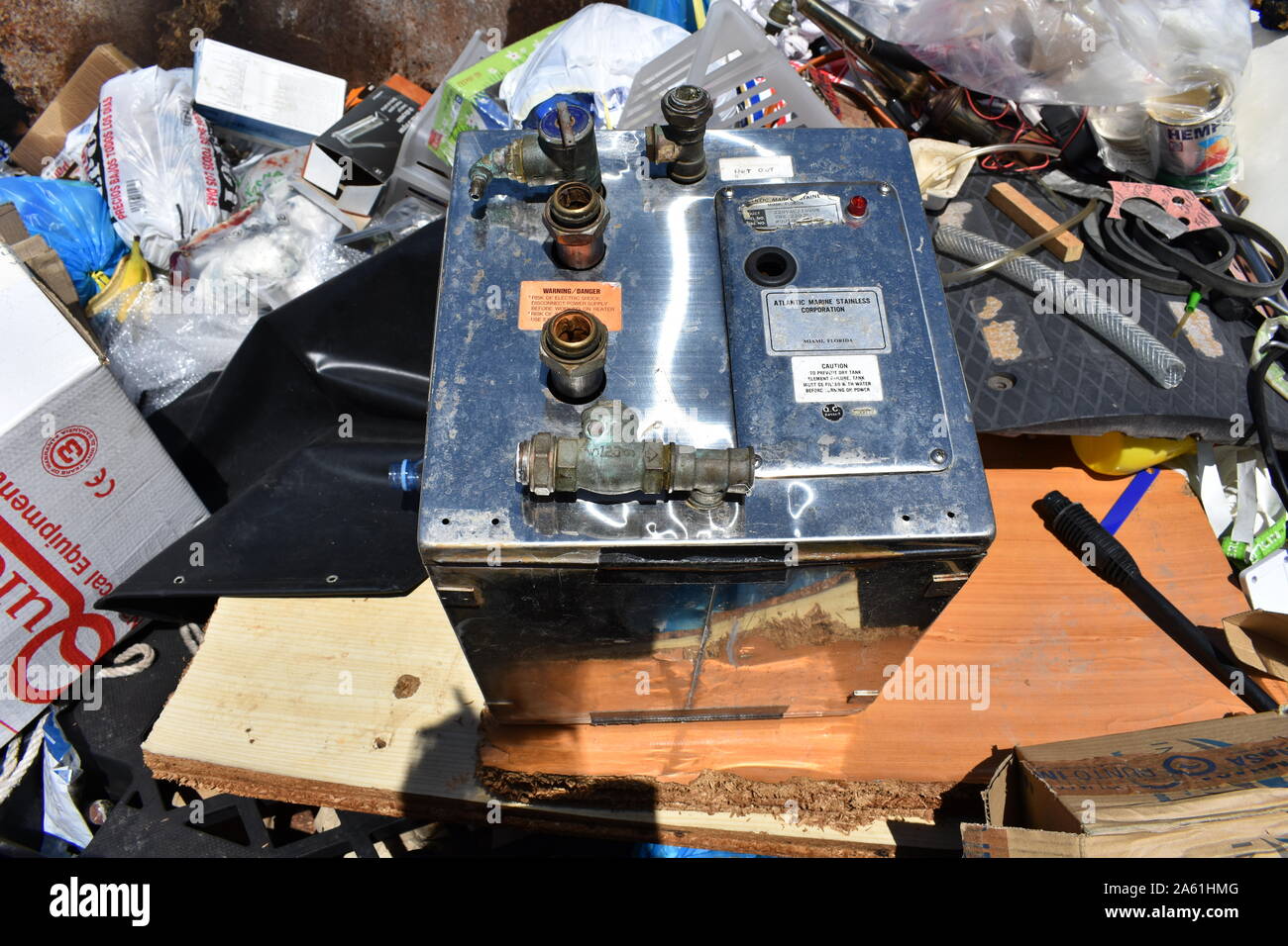 Discarded water heater and other rubbish in a skip Stock Photo - Alamy