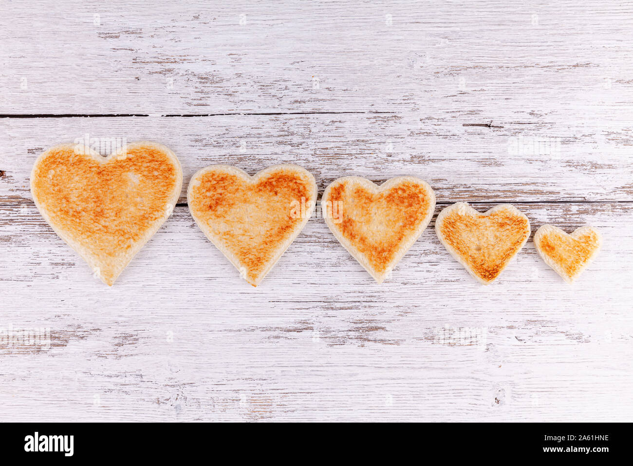 Toasted bread hearts together in a row, concept of support in big ...