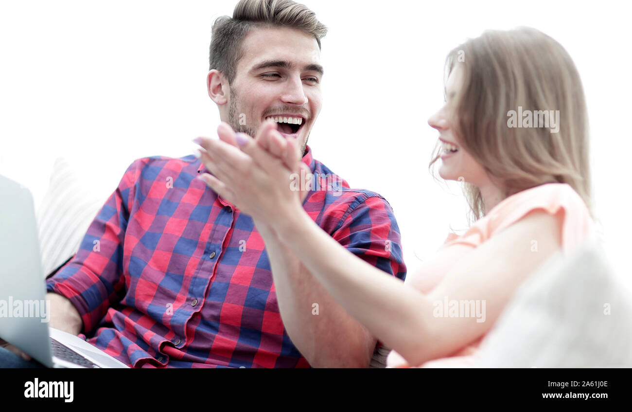 young man and his girlfriend cheering for their team while sitting on ...