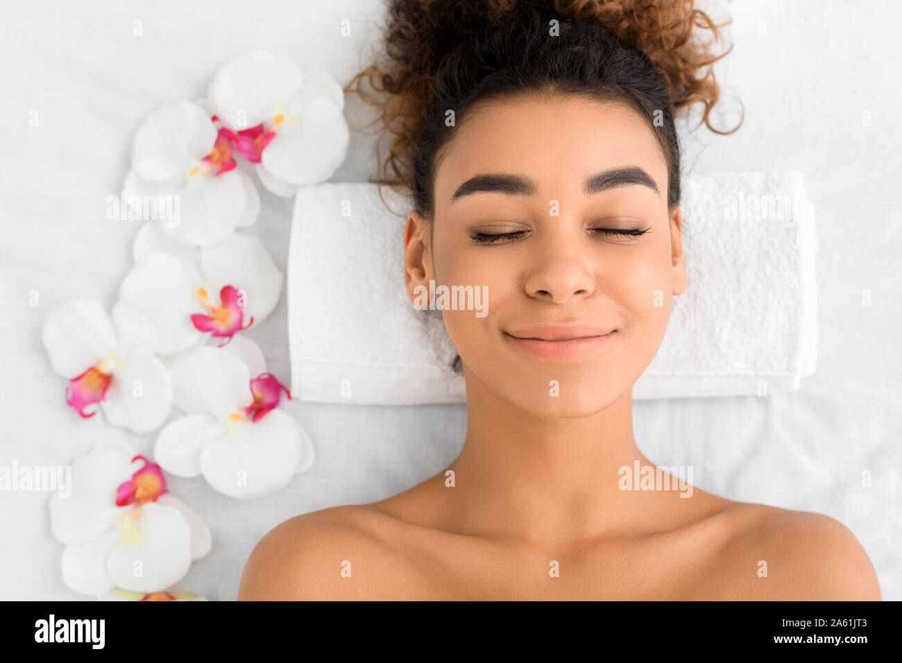 African-american woman getting face treatment at beauty salon Stock ...