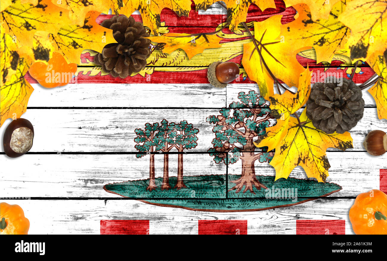 Prince Edward Island flag on autumn wooden background with leaves and ...