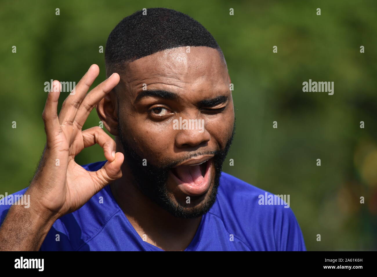 African Male Athlete And Okay Sign Stock Photo - Alamy