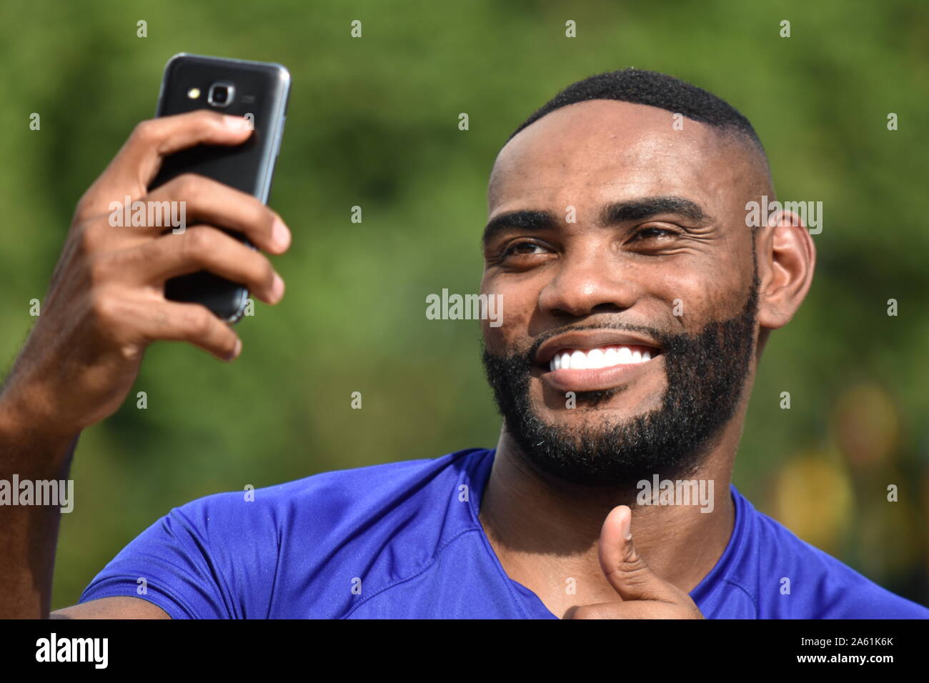 Male Athlete Using Cell Phone And Happy Stock Photo - Alamy