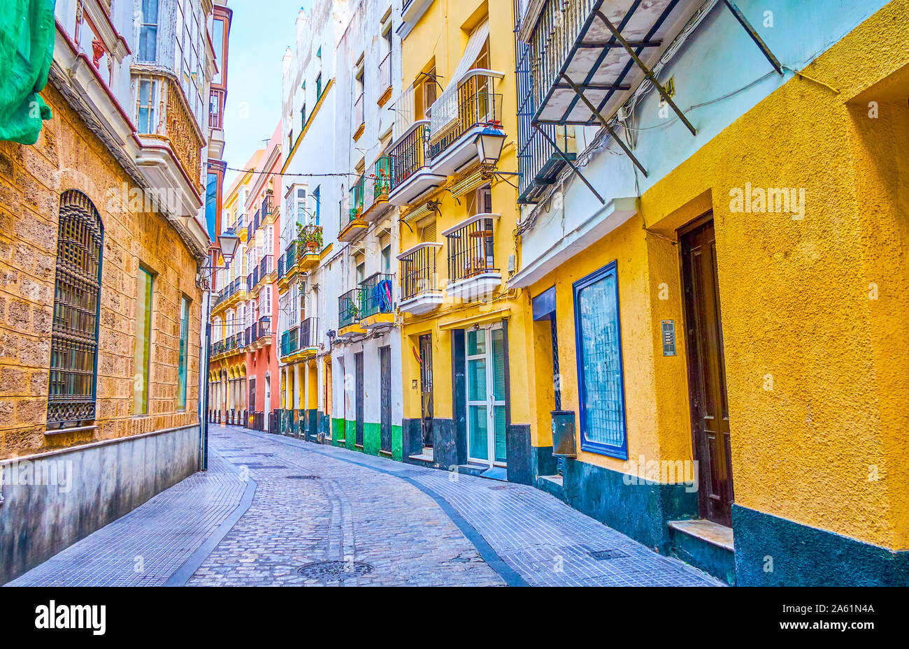 The curved narrow street in residential neighborhood of old Cadiz ...