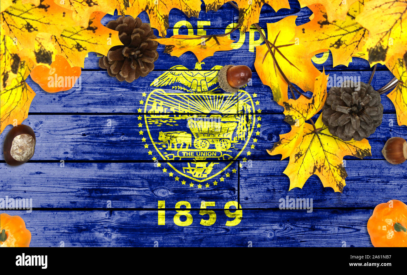 State of Oregon flag on autumn wooden background with leaves and good ...