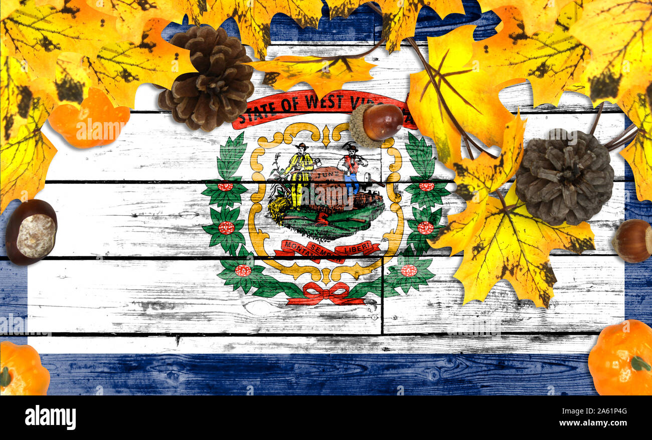 State of West Virginia flag on autumn wooden background with leaves and ...