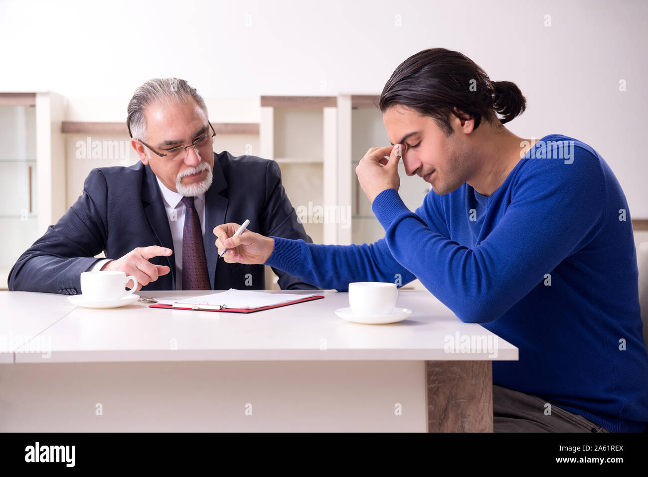 The male real estate agent and male client in the apartment Stock Photo ...
