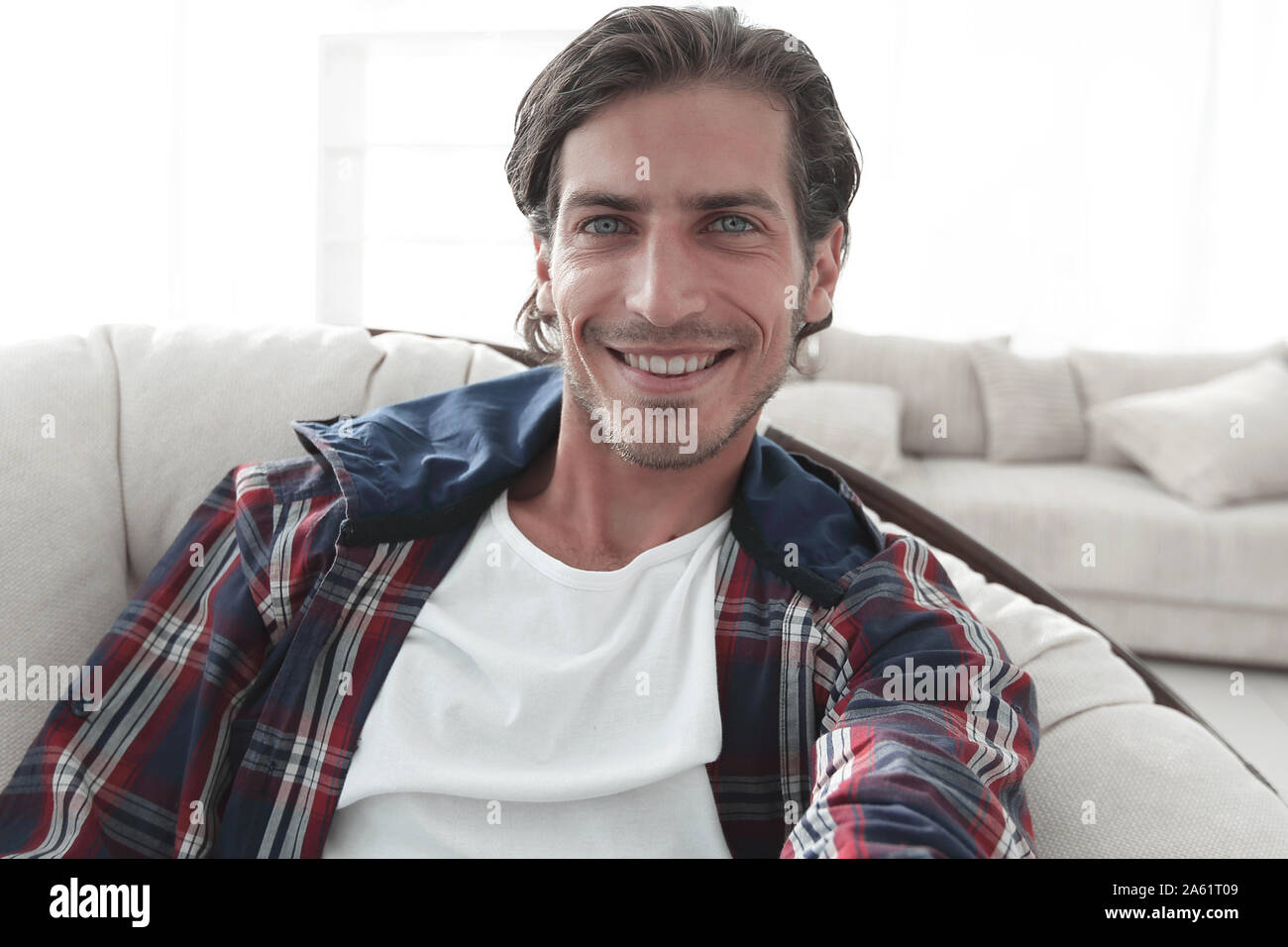 confident guy sitting in a chair and holding out his hand Stock Photo ...