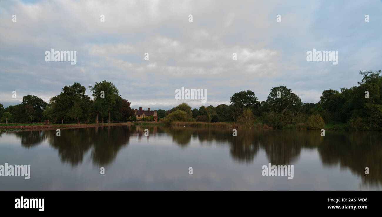 Packwood House viewed from lake with reflections of treeline Stock Photo - Alamy
