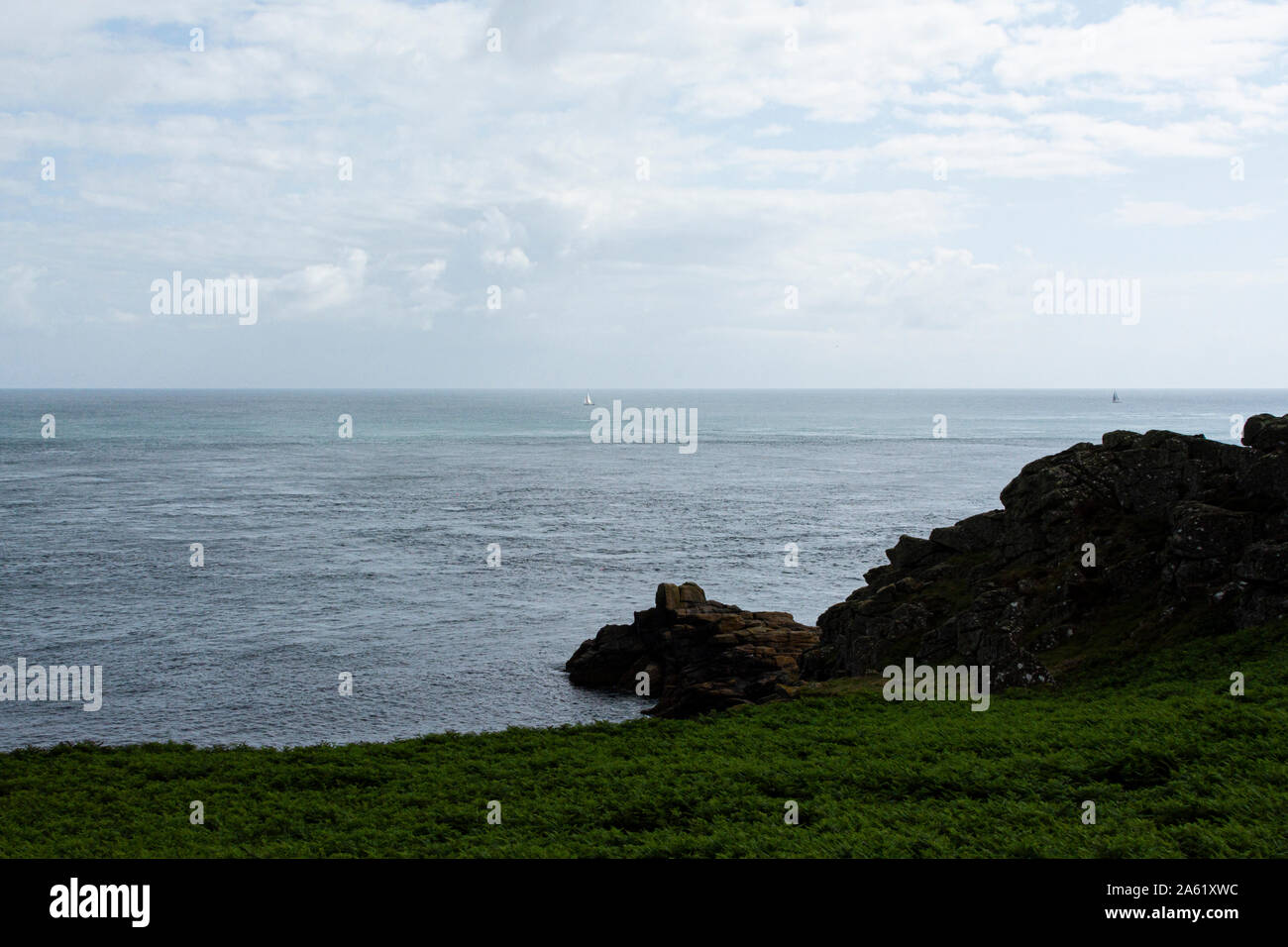 Rocks protruding out into the sea on the eastern coast of St Martin's ...