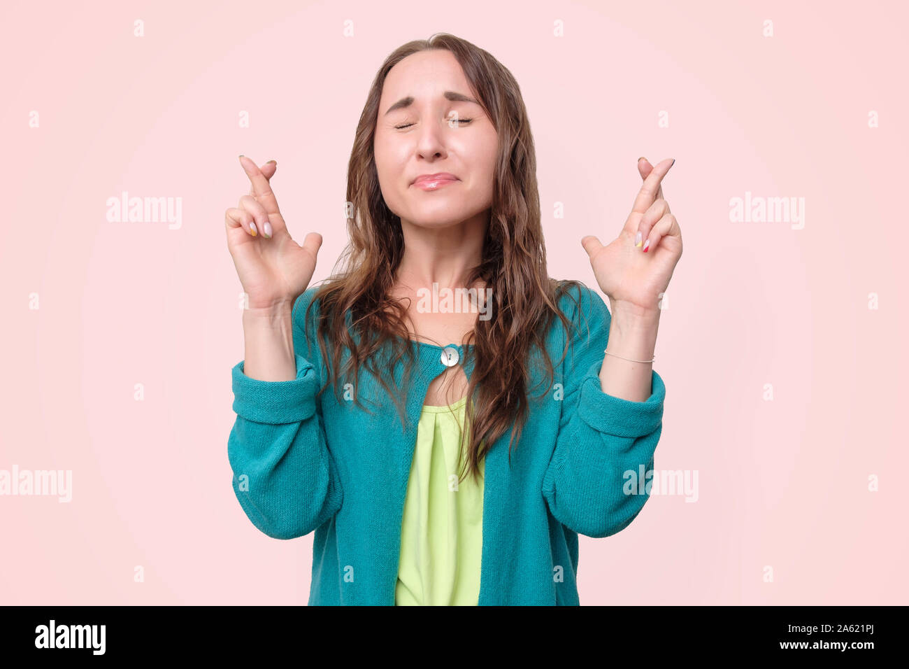 Woman keeping fingers crossed, hoping for good luck Stock Photo - Alamy