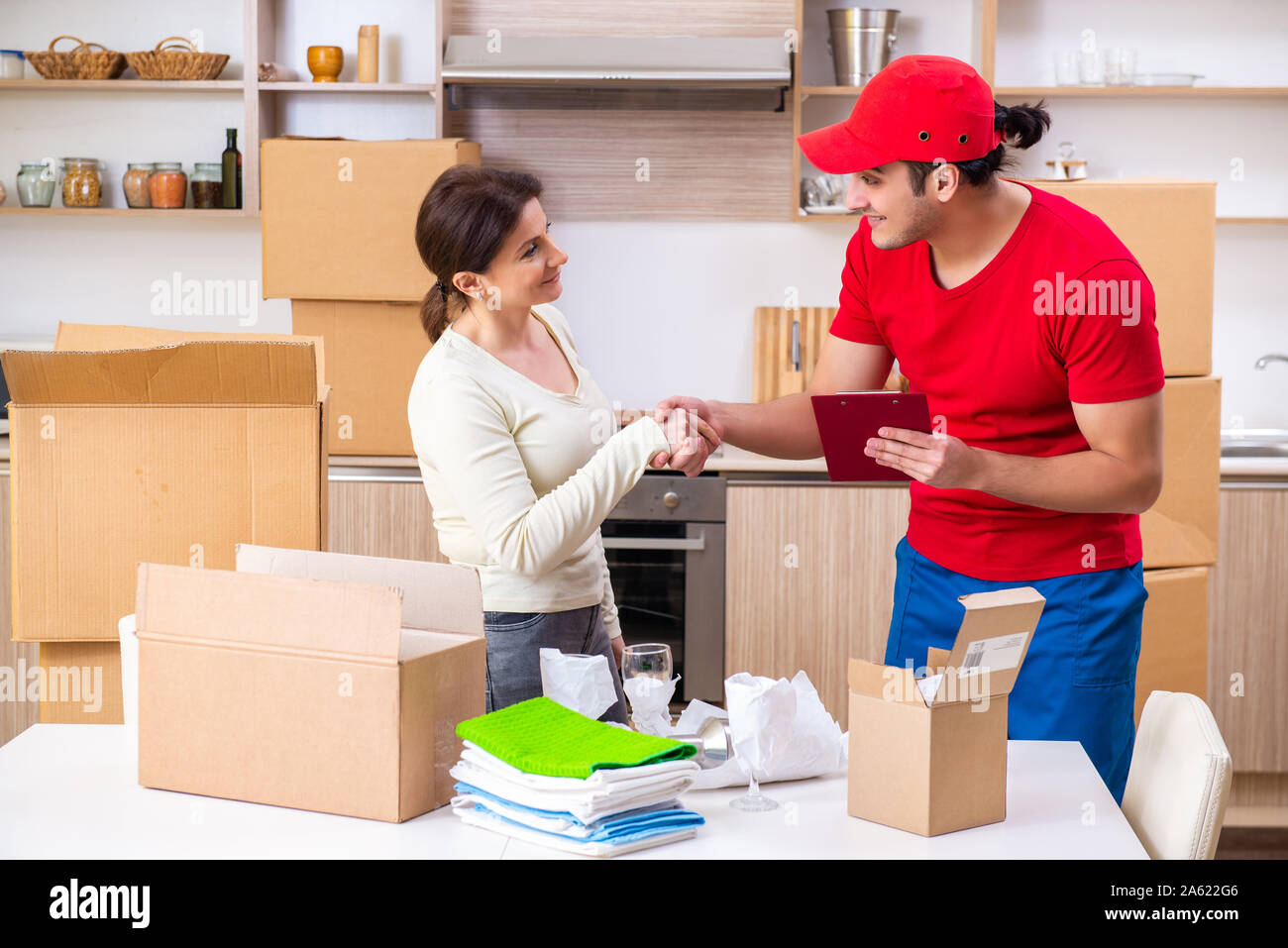 The young male contractor and female customer in moving concept Stock ...