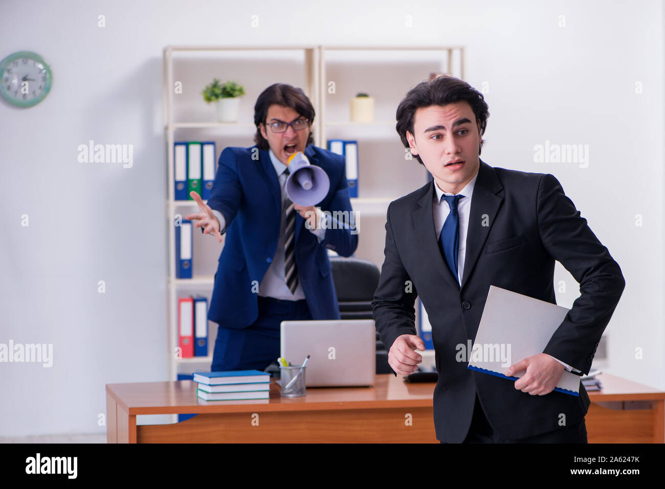 The boss and his male assistant working in the office Stock Photo - Alamy