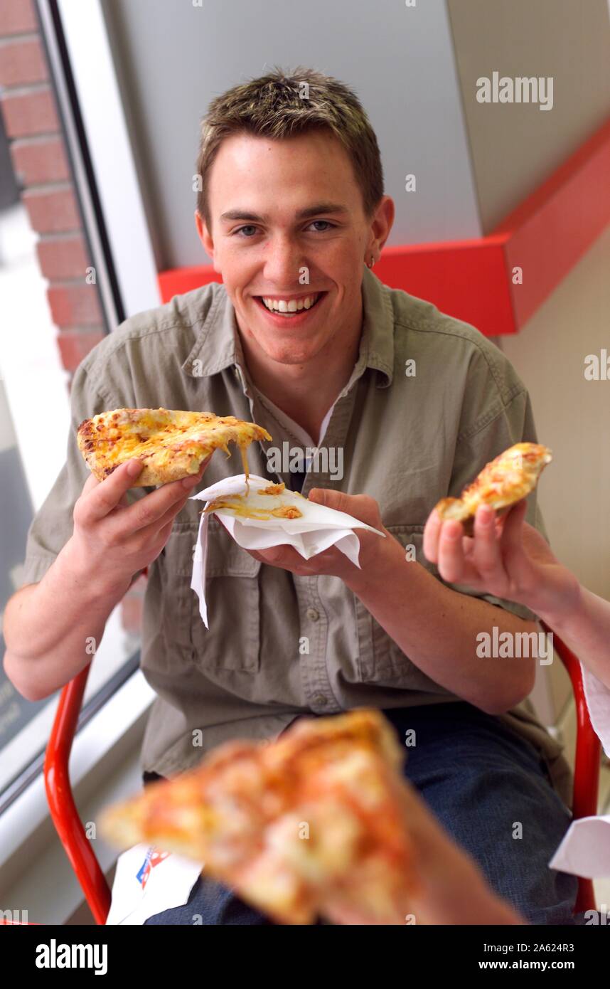 Boy eating slice pizza in hi-res stock photography and images - Alamy