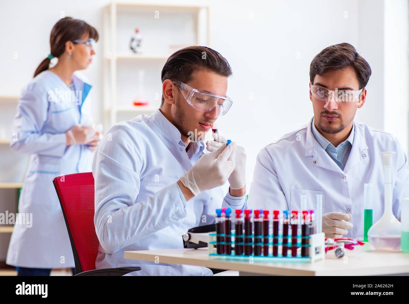 The team of chemists working in the lab Stock Photo - Alamy