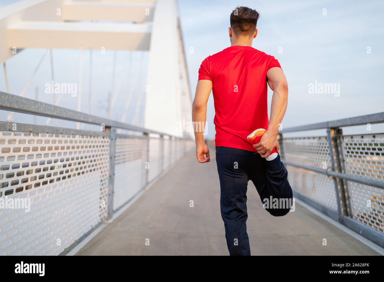 Male runner stretching hi-res stock photography and images - Alamy