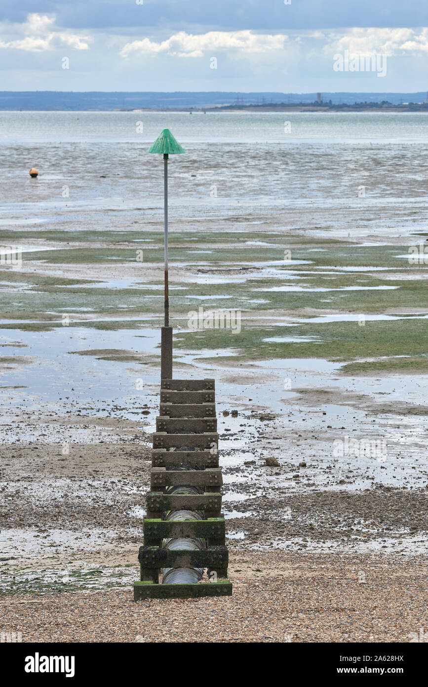 Outfall pipe carrying waste into the river Thames estuary on the ...