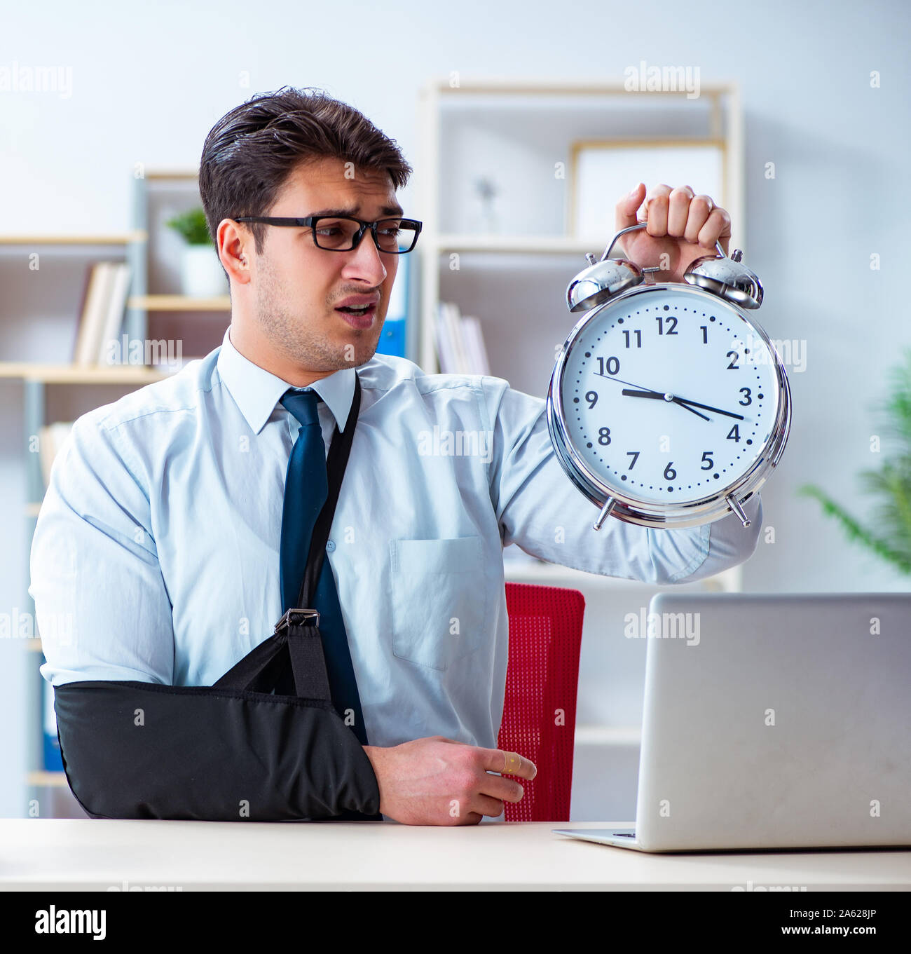 The businessman with broken arm working in office Stock Photo - Alamy