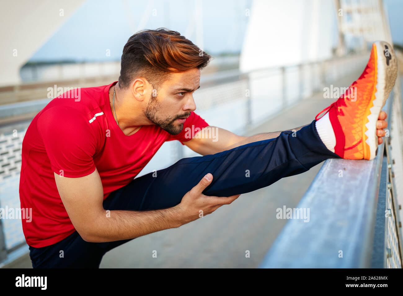 Male runner stretching hi-res stock photography and images - Alamy