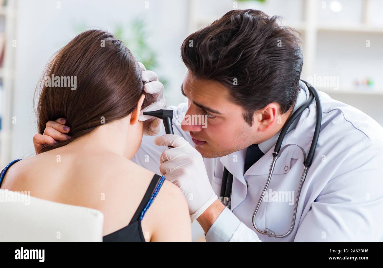 The doctor checking patients ear during medical examination Stock Photo ...