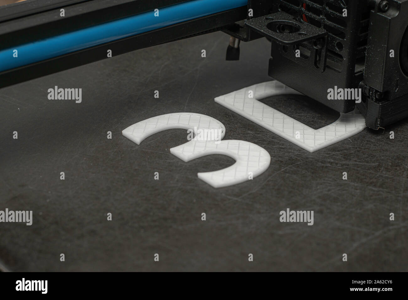 3D printer prints the word 3D with white filament PLA Stock Photo - Alamy
