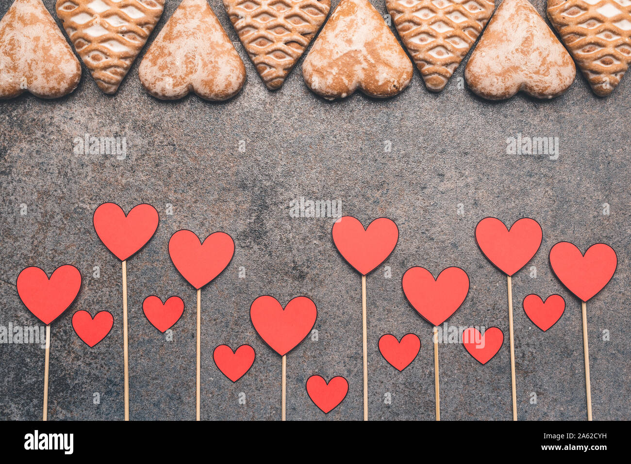 Hearts made of paper placed on sticks and handmade gingerbread. The ...