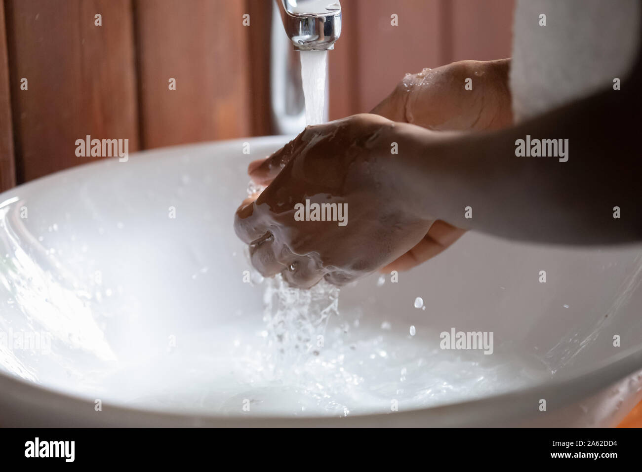 Young african ethnicity guy washing hands under running water Stock ...
