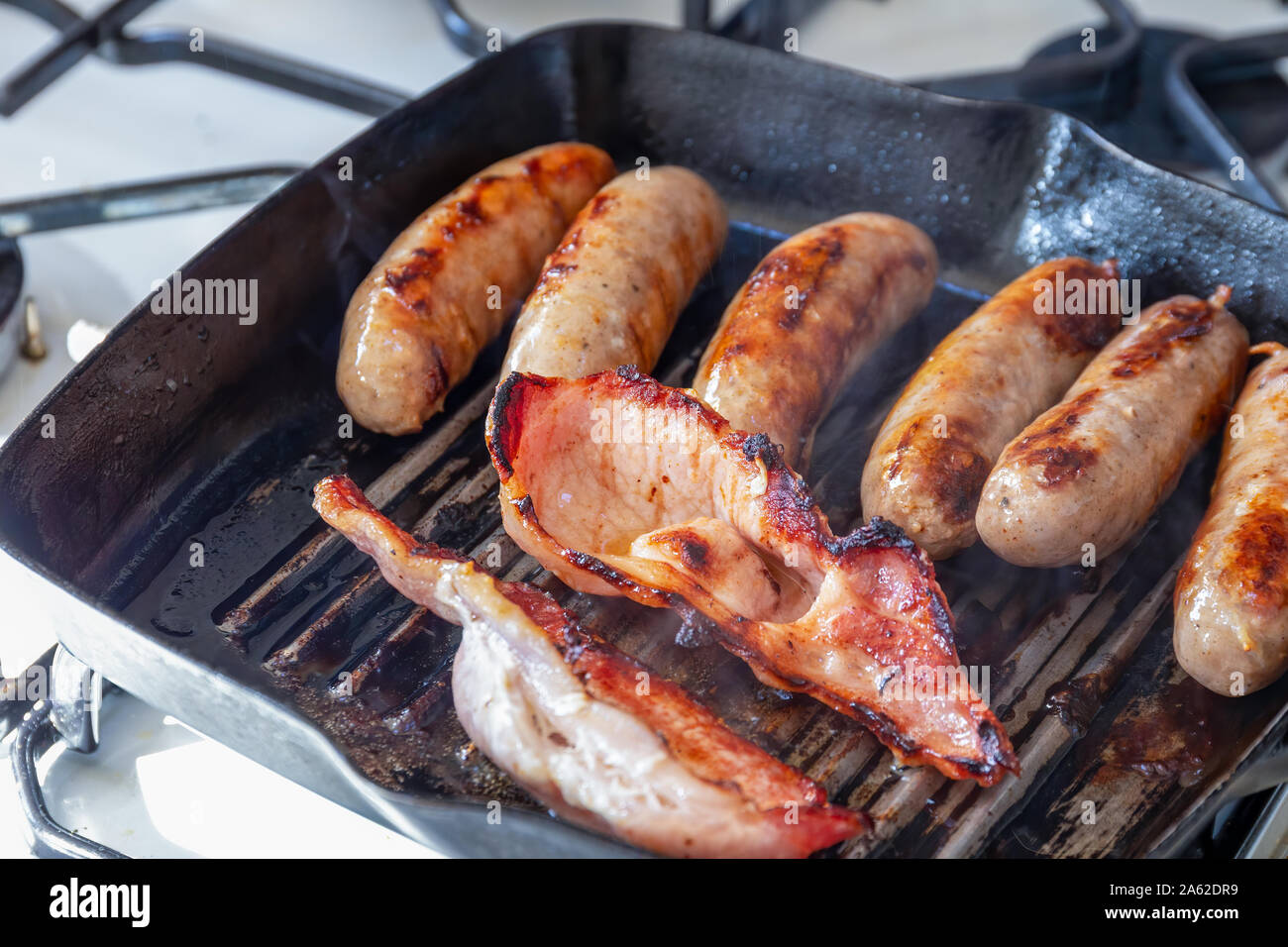 Sizzling sausages in griddle hi-res stock photography and images - Alamy