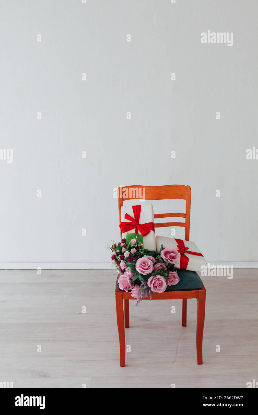 one chair with gifts in the interior of the white room Stock Photo - Alamy