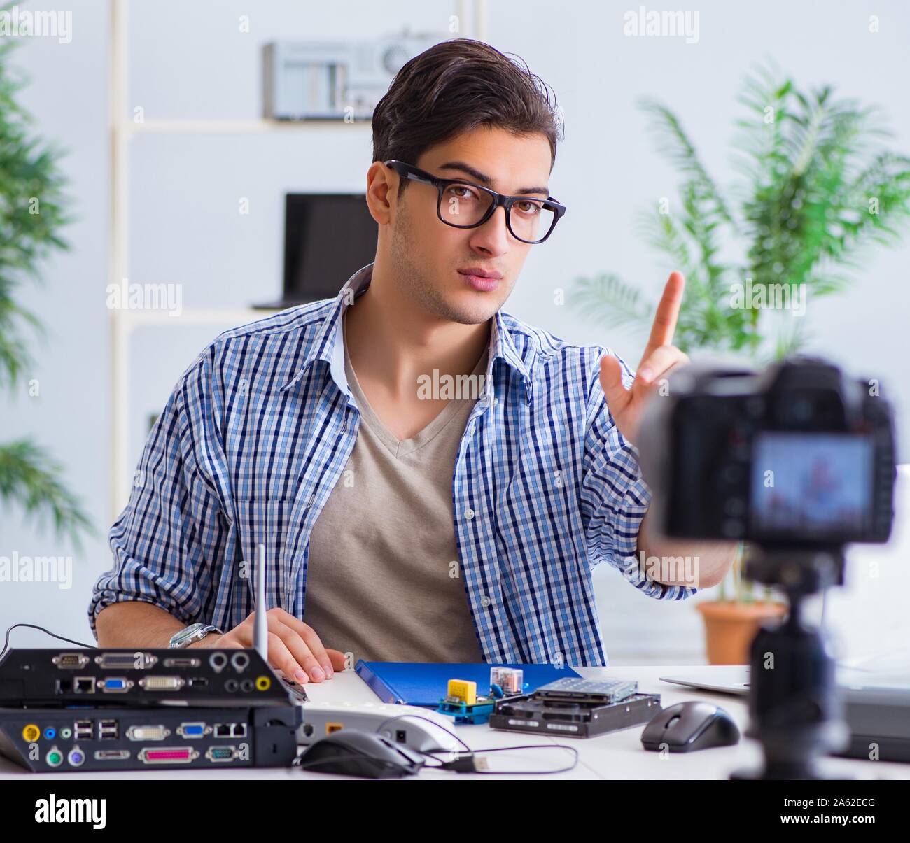 The vlogger recording computer repair on camera for vlog blog Stock ...