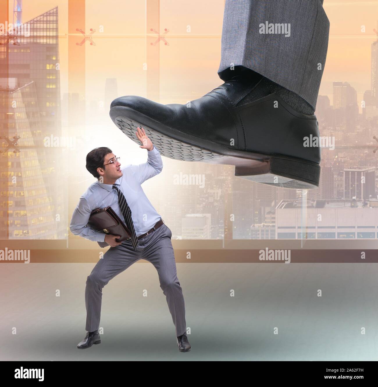 Bad angry boss stamping on employee in business concept Stock Photo - Alamy