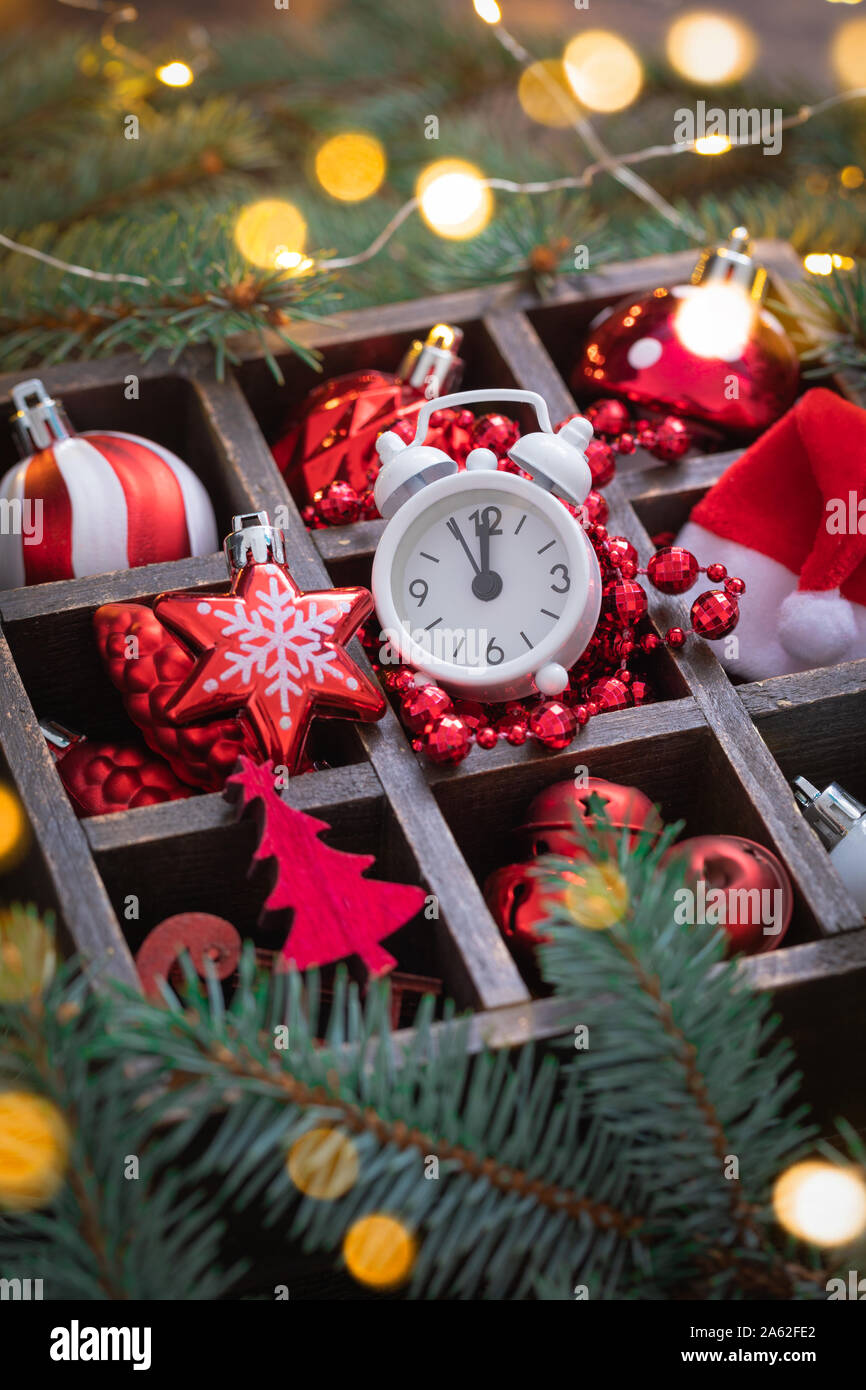 Christmas red and white glass toys, alarm clock, santa claus hat in the ...