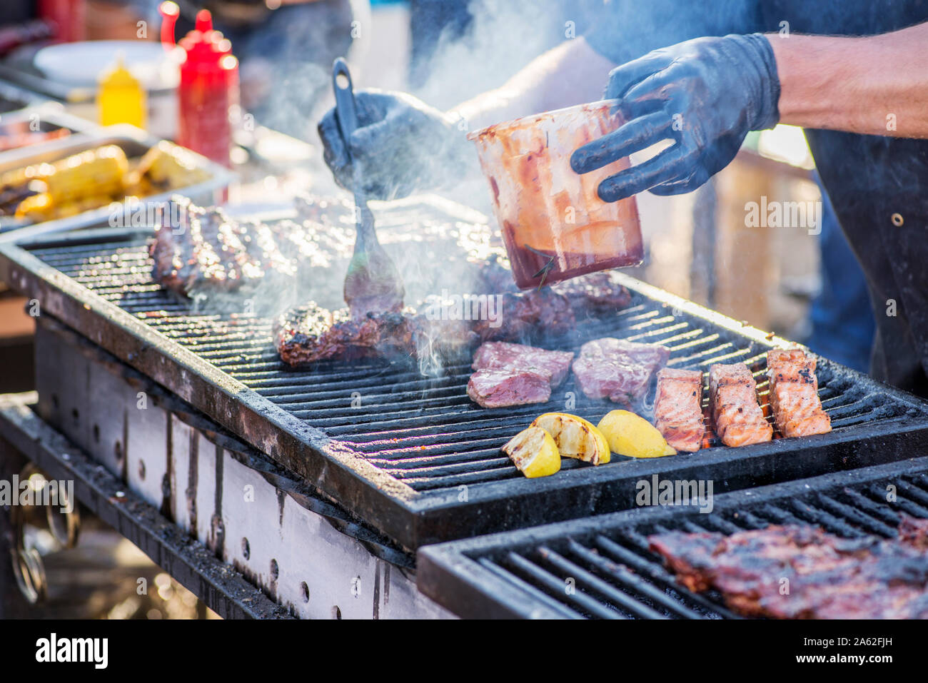 Roasted meat cooked at barbecue. Grilled kebab cooking on metal skewer ...