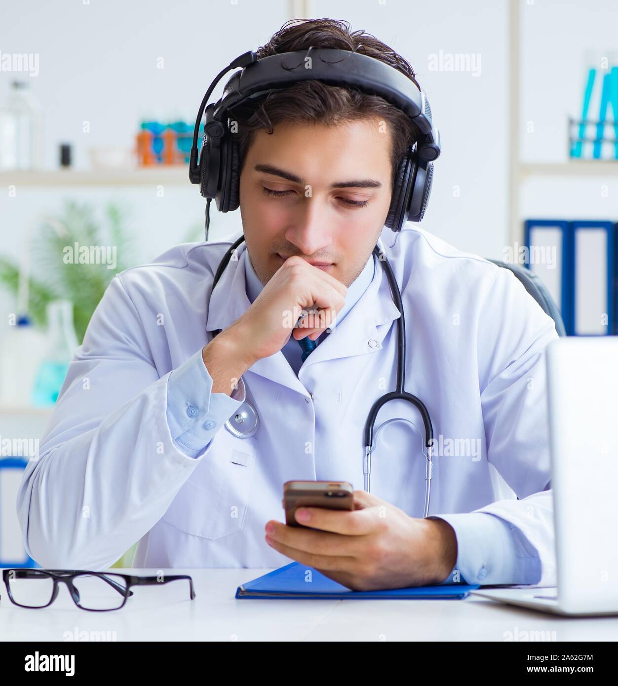 The male doctor listening to patient during telemedicine session Stock ...