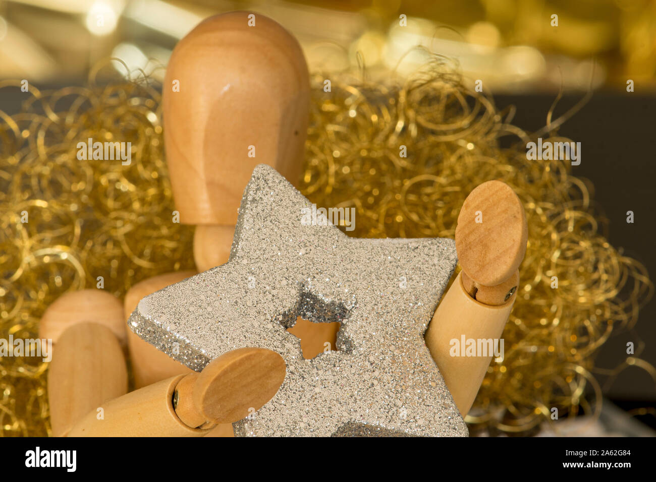 Wooden doll with silver star in hand Stock Photo - Alamy