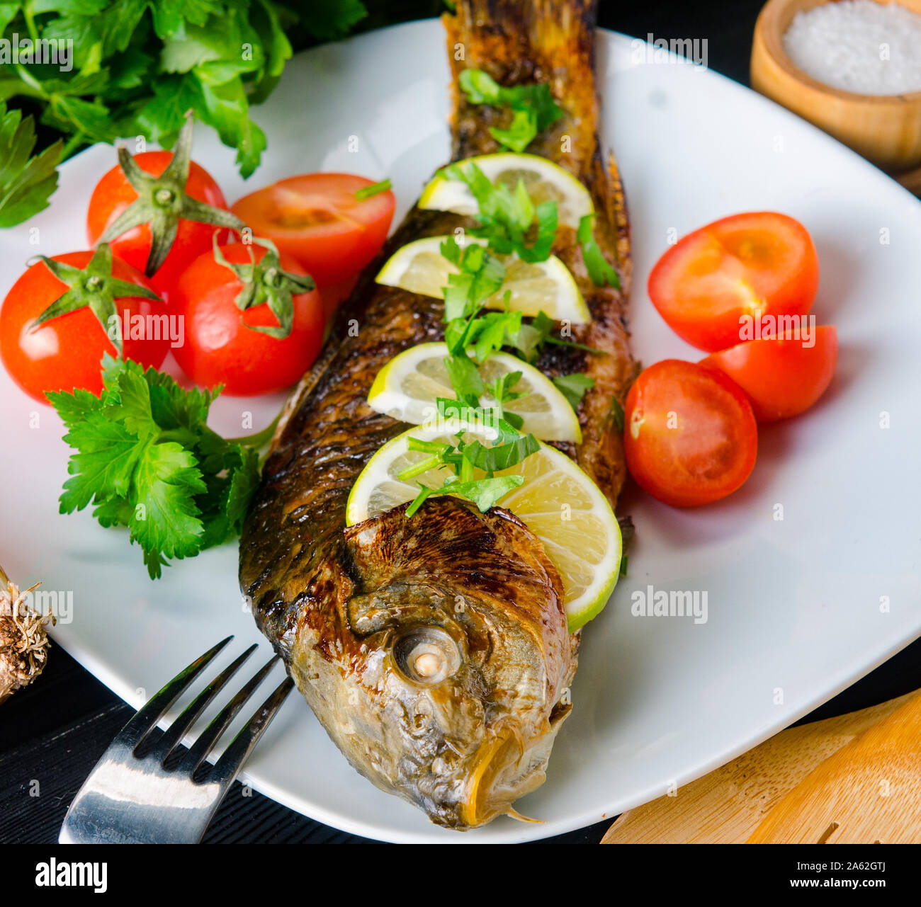 The fried fish served on the plate Stock Photo - Alamy