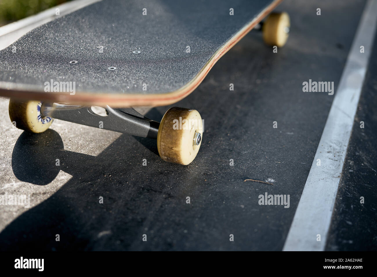 Closeup of skateboard in concrete skatepark on warm day Stock Photo - Alamy