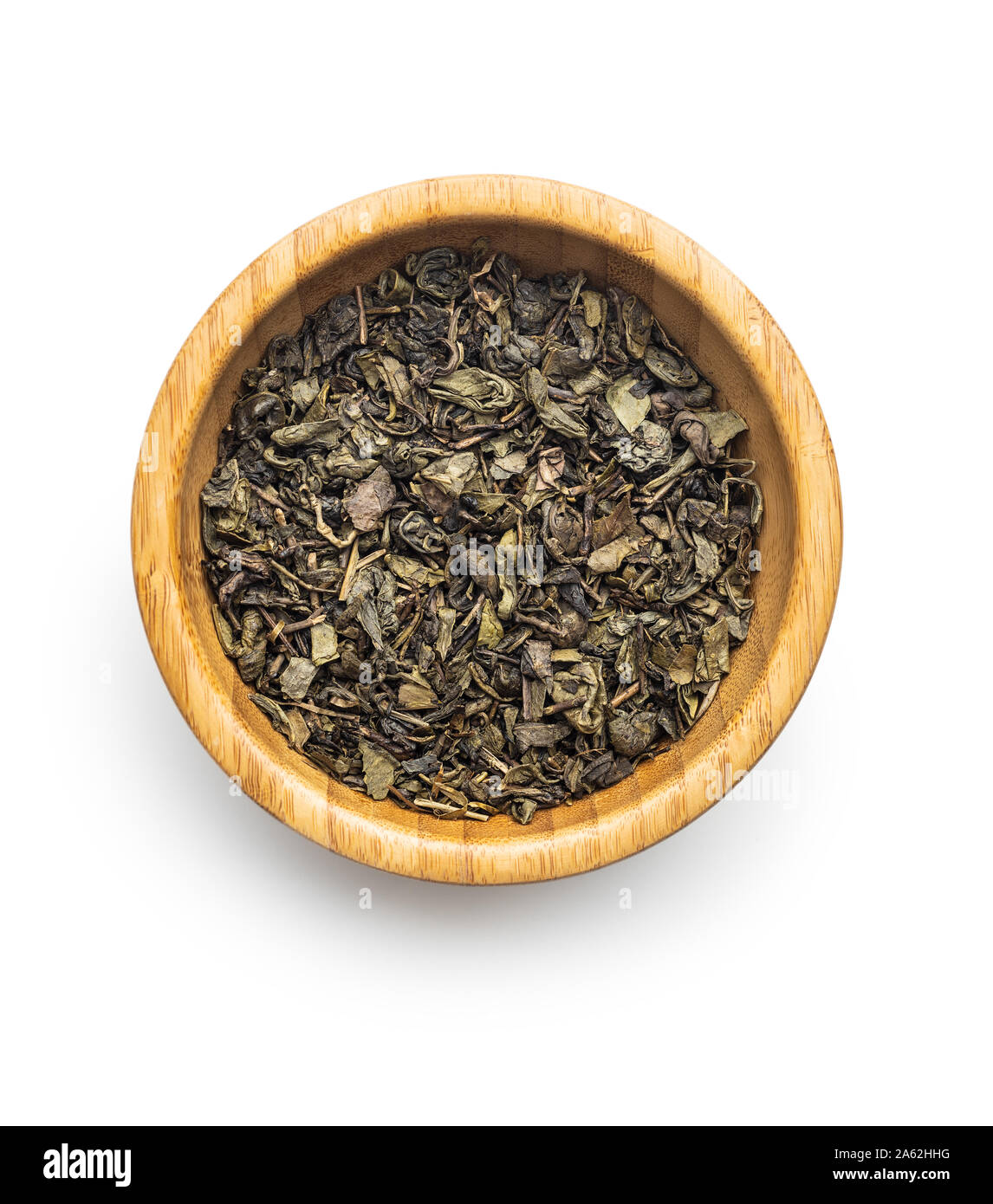 Dried green tea leaves in bowl isolated on white background Stock Photo ...