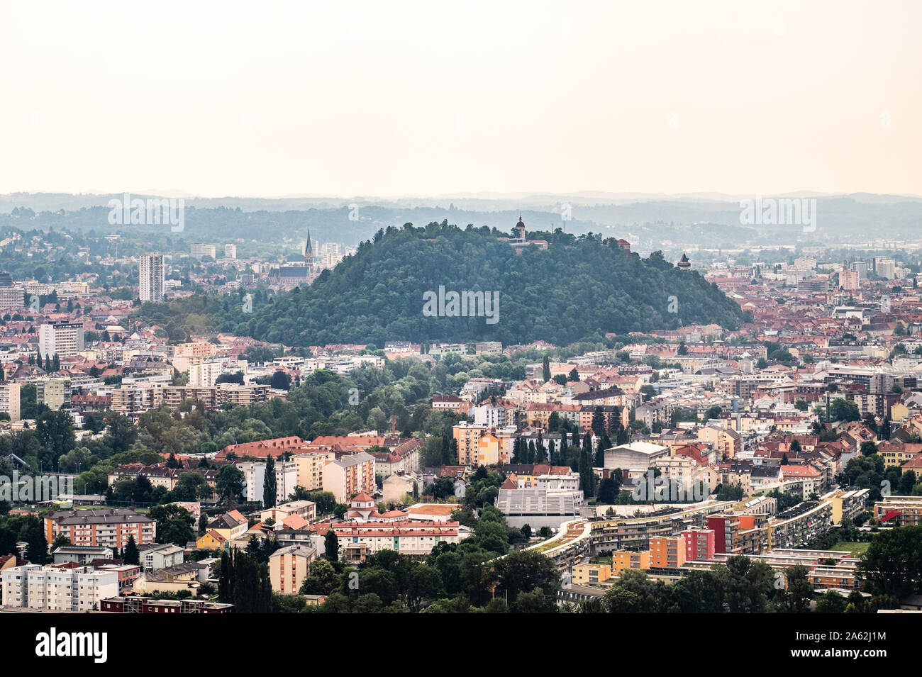 Aerial view of center city Graz from helicopter drone with hill ...