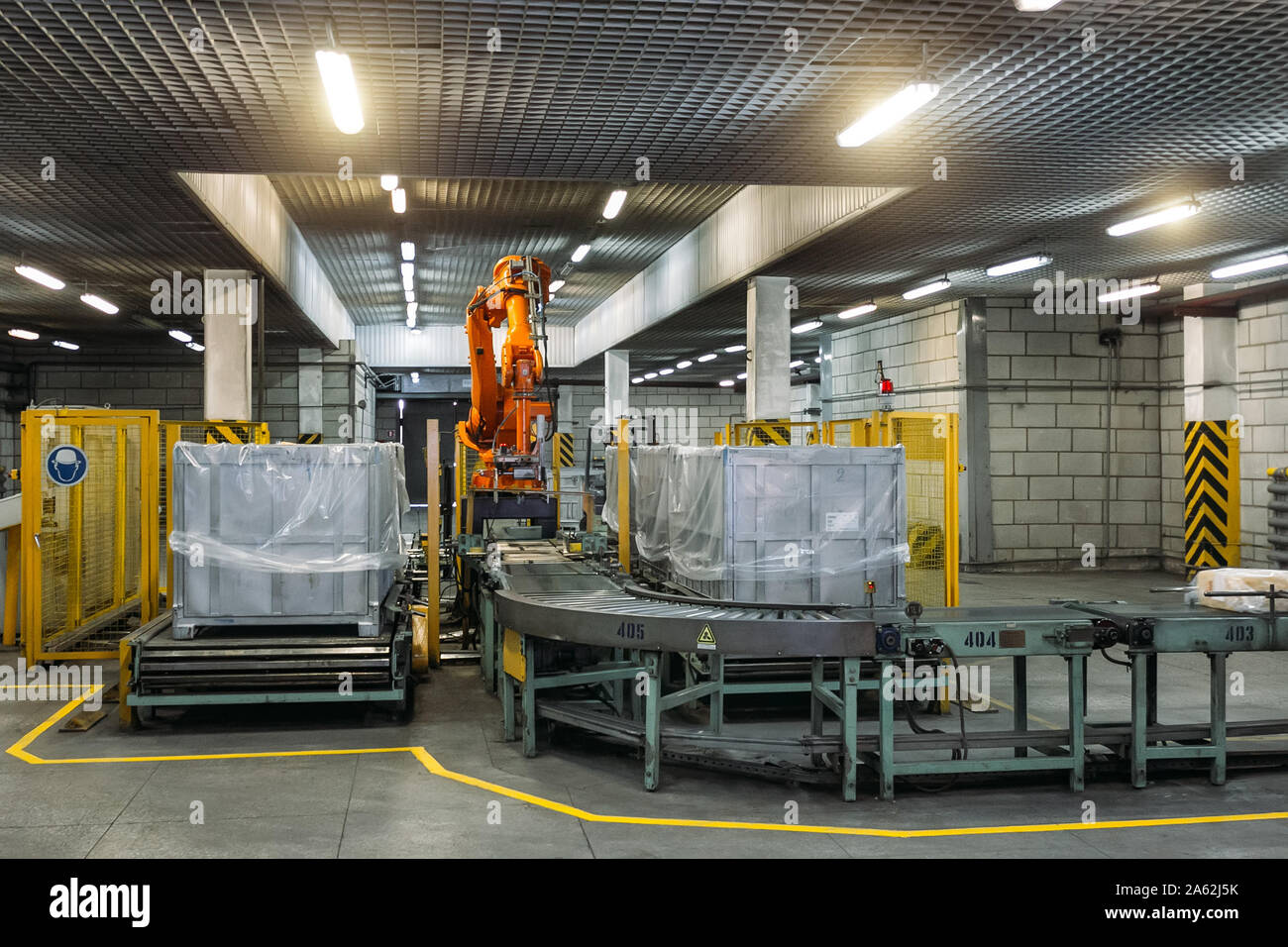 Robot Hand manipulator packaging factory products from conveyor into ...