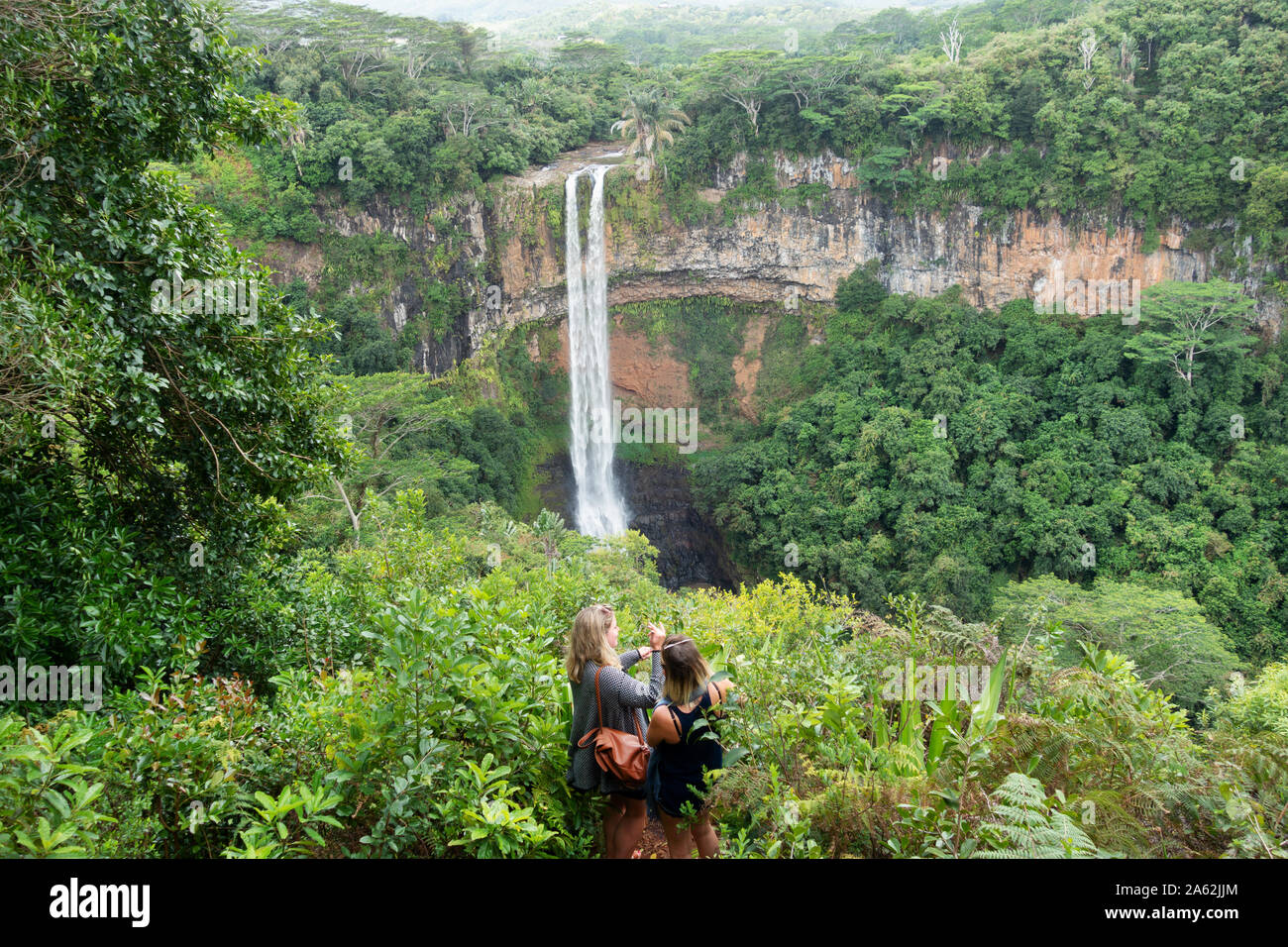 Mauritius tourism; tourists looking at the Chamarel waterfalls ...