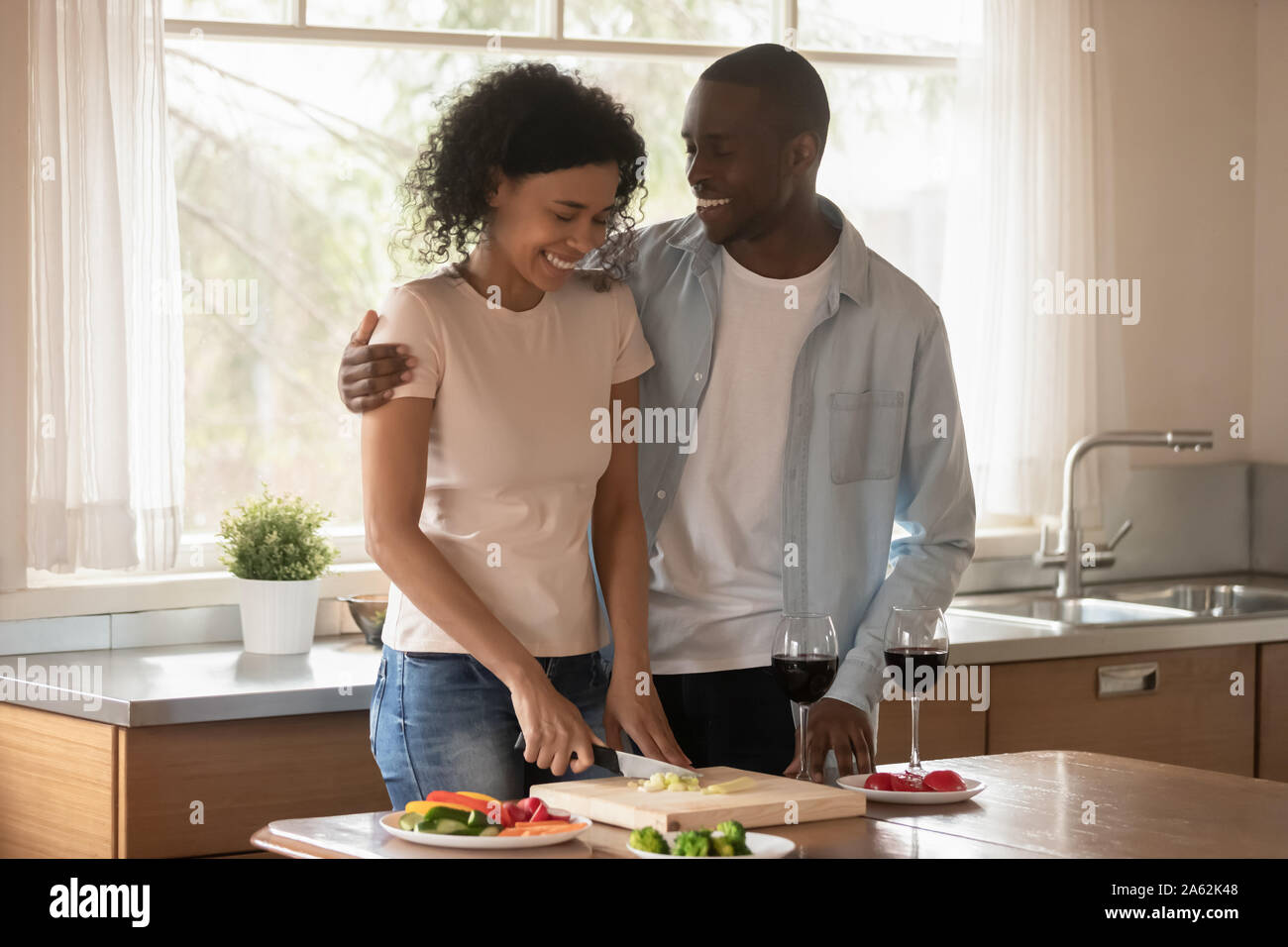 Joyful happy african american spouse cooking together in kitchen Stock ...